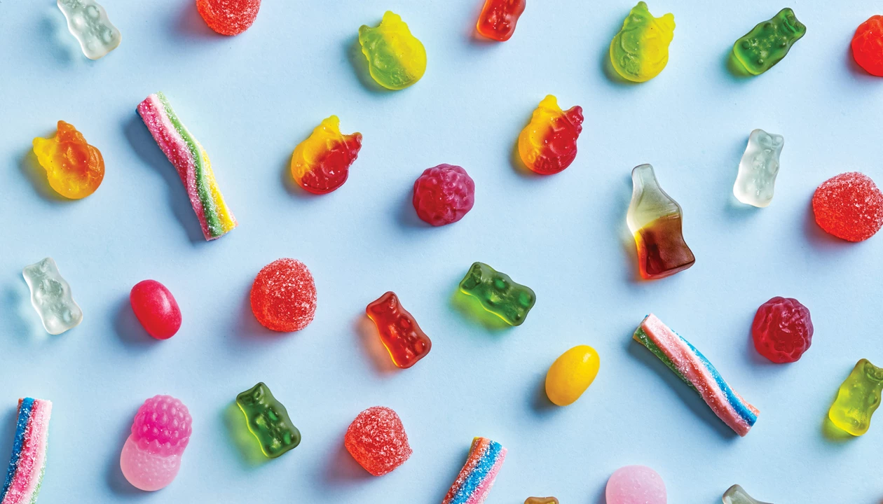 What ingredients give gummy candies hard or soft textures?