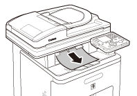 Removing jammed paper from the output tray.